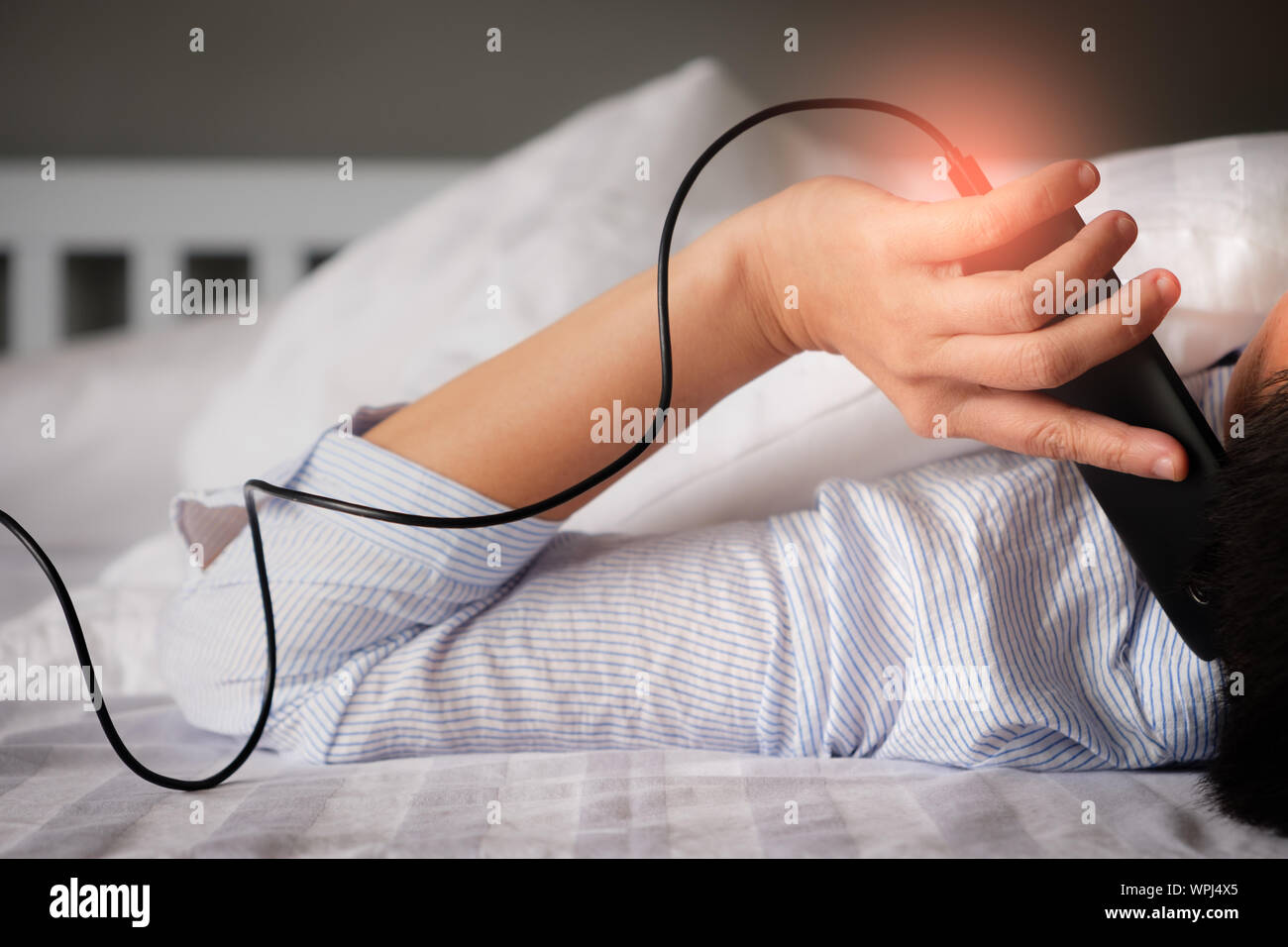 Women are using a mobile phone while charging the battery. Red light ...