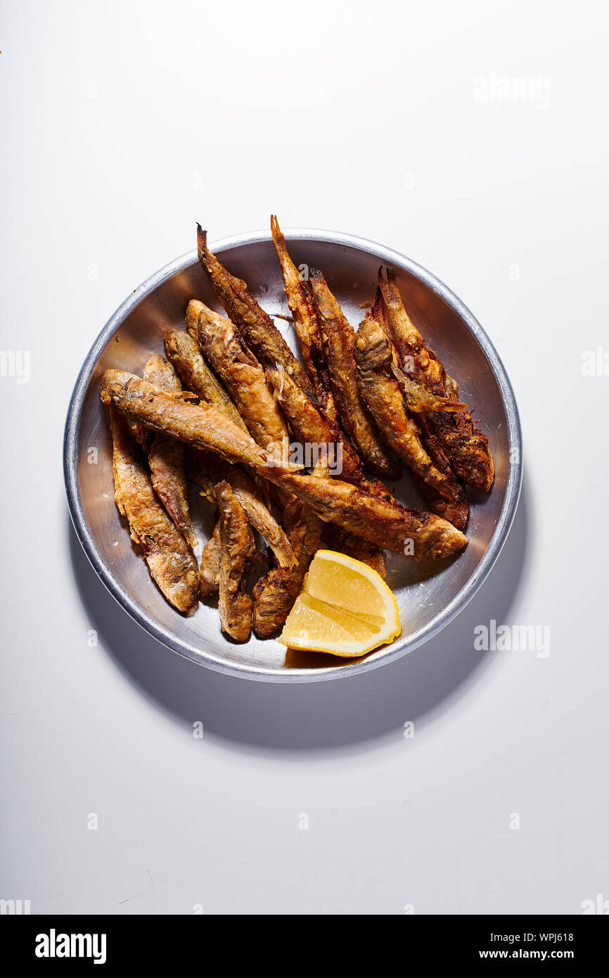 Red mullet fish deep-fried and served with lemon Stock Photo - Alamy