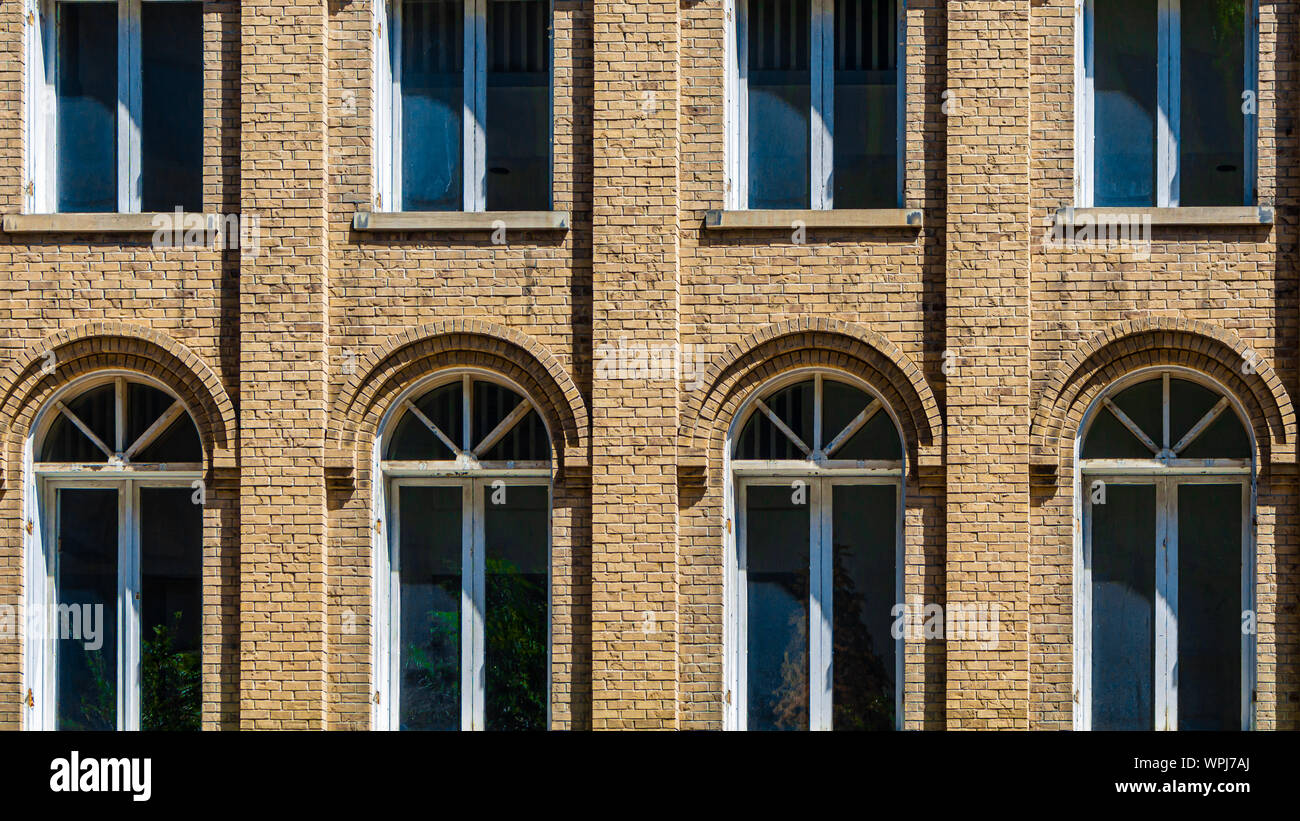 The street-facing front of low-rise apartments features a brick facade ...