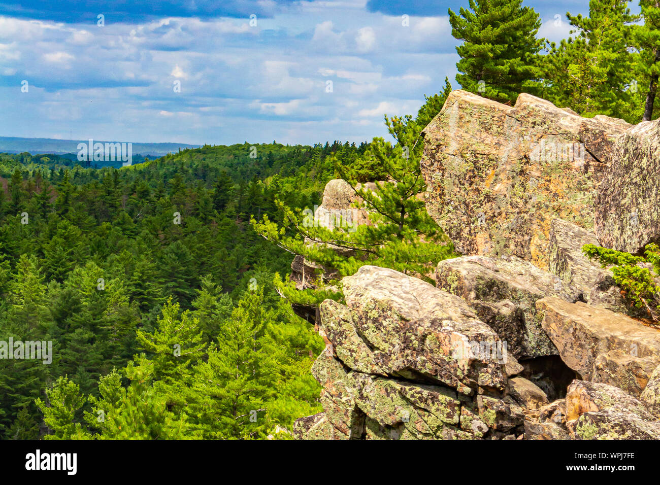 A view of rolling forest hills in Ontario, Canada on a partly cloudy ...