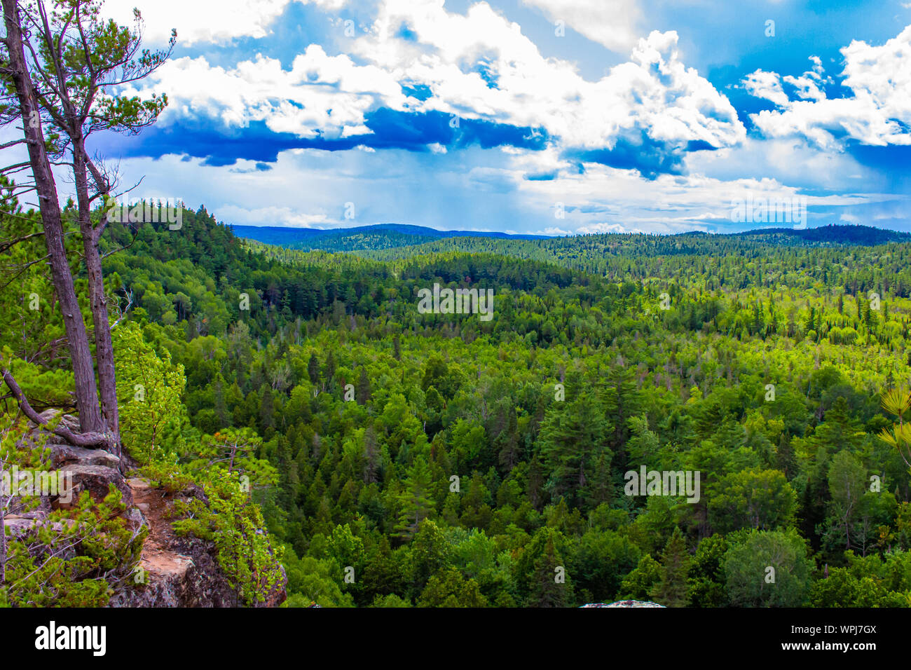 A view of rolling forest hills in Ontario, Canada on a partly cloudy ...