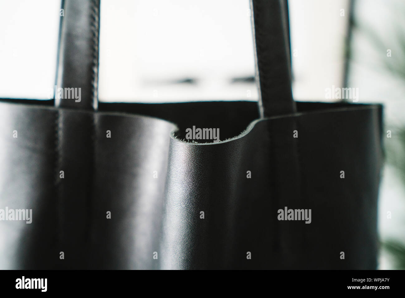 Close up shoot of a black leather tote bag Stock Photo - Alamy