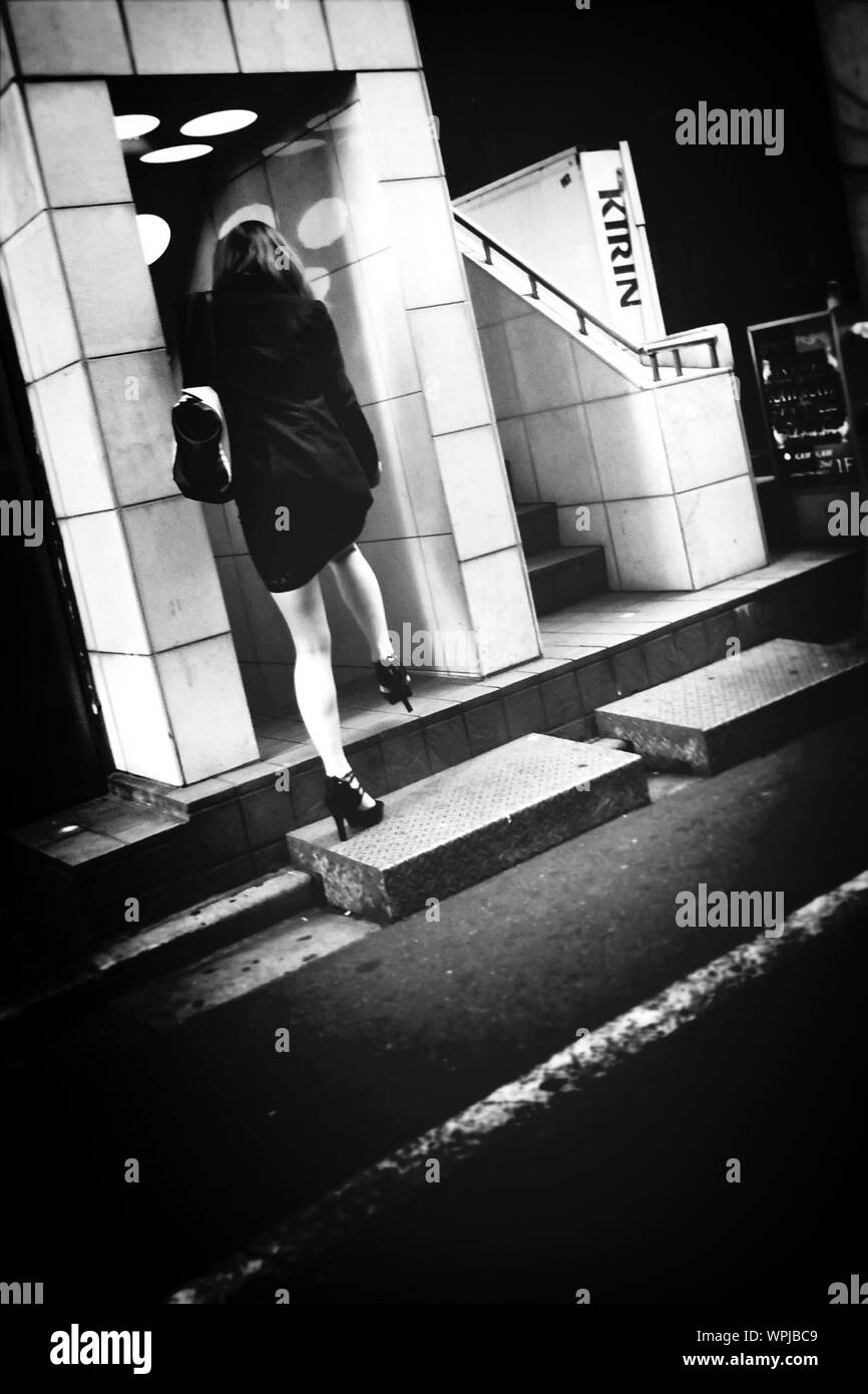 Woman entering bathroom hi-res stock photography and images - Alamy