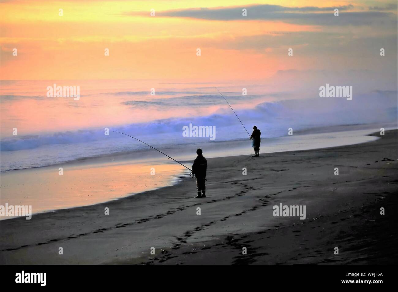 Two men beach fishing hi-res stock photography and images - Alamy