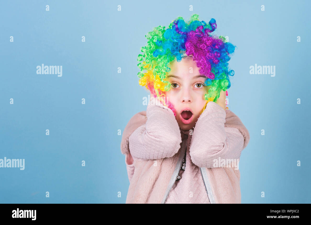 Wearing the foolish clown face. Surprised small clown with opened mouth ...