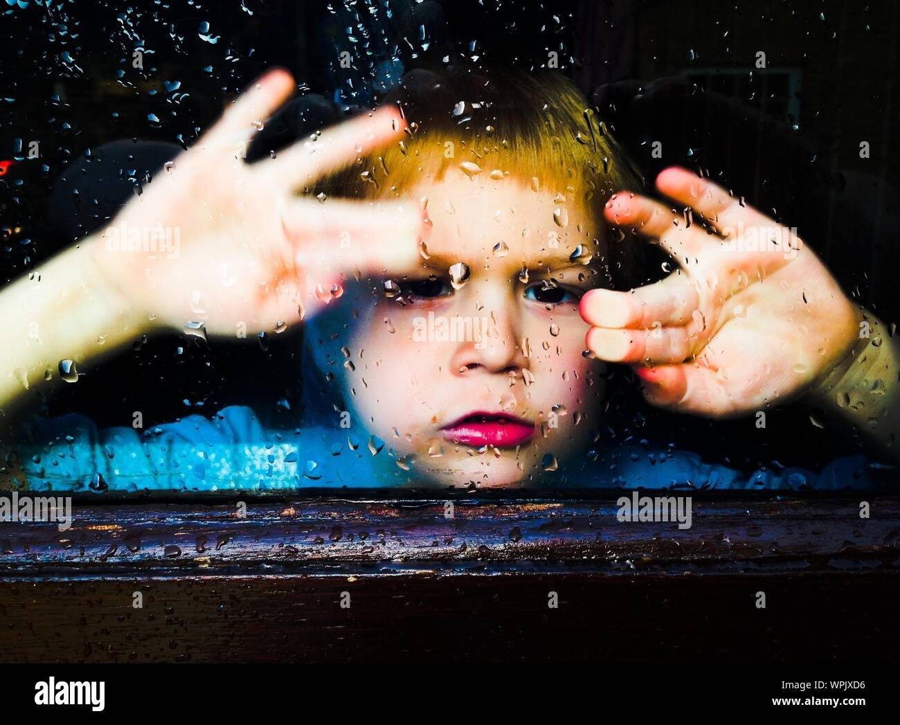 Boys face through glass hi-res stock photography and images - Alamy