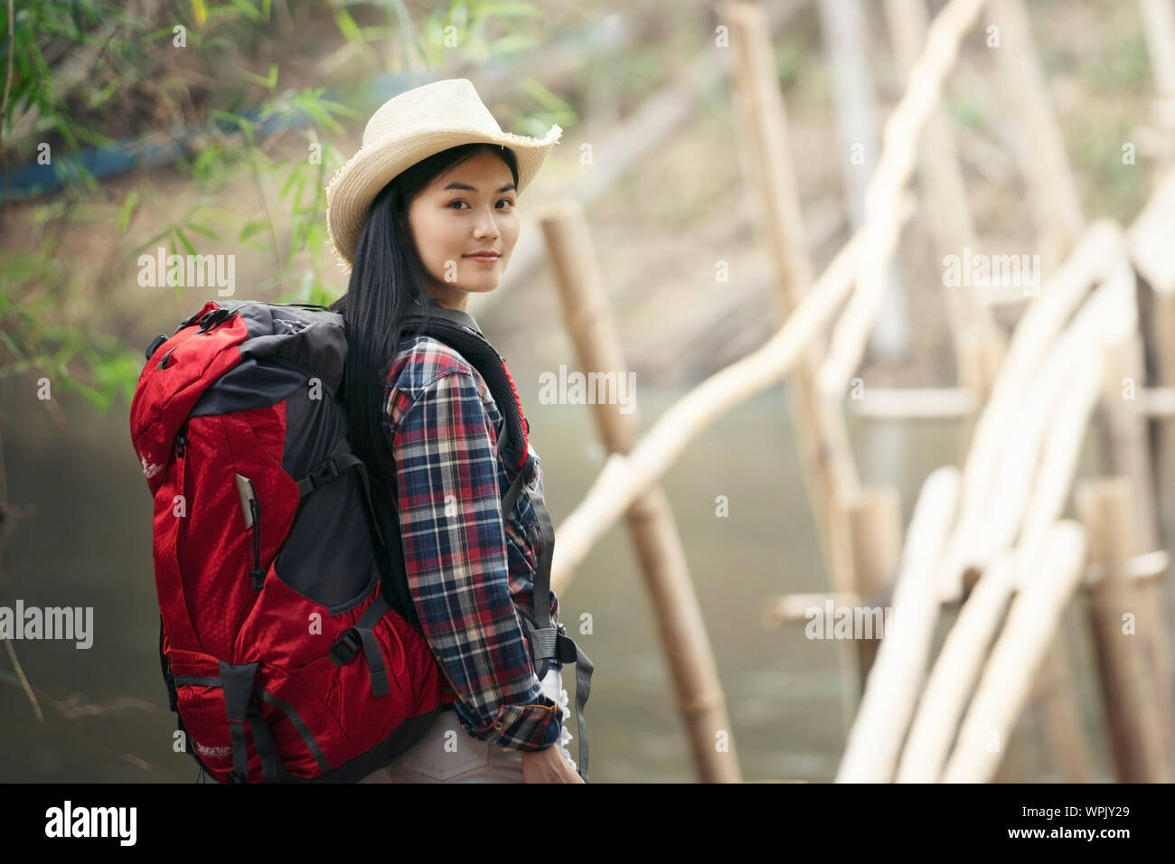 Backpacker woman with nature background Stock Photo - Alamy