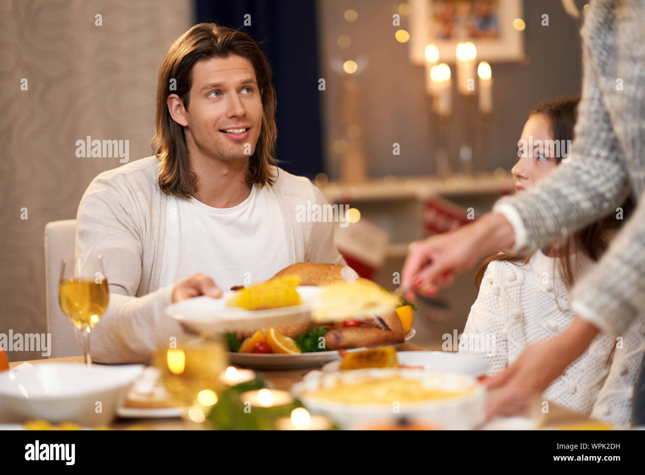 Beautiful family eating Christmas dinner at home Stock Photo - Alamy