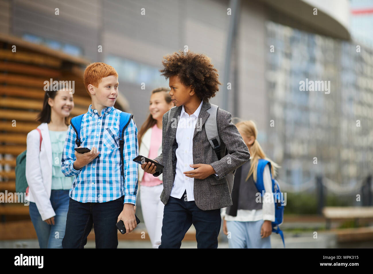 Two boys talking street hi-res stock photography and images - Alamy