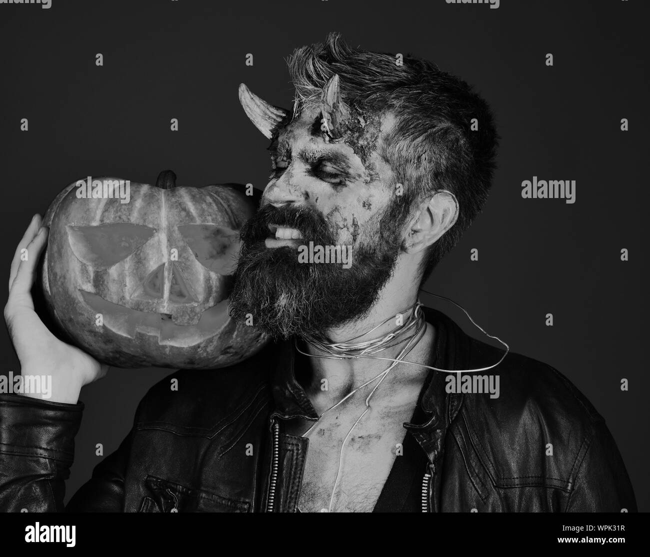 Devil or monster with October decorations. Demon with horns and demonic ...