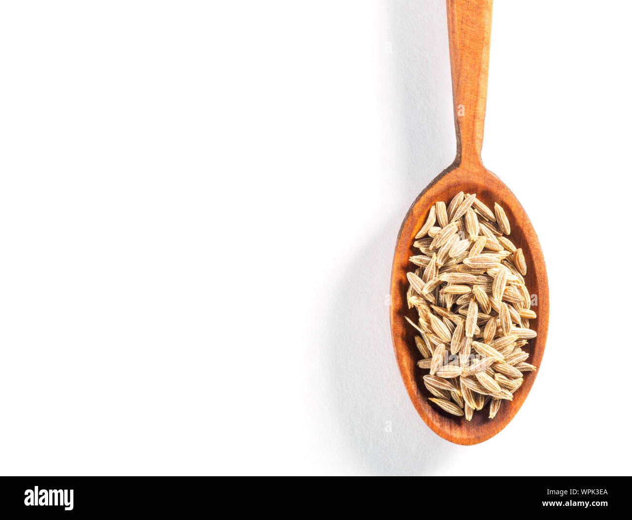Cumin seeds (Cuminum), Jeera in wooden spoon on a white background ...