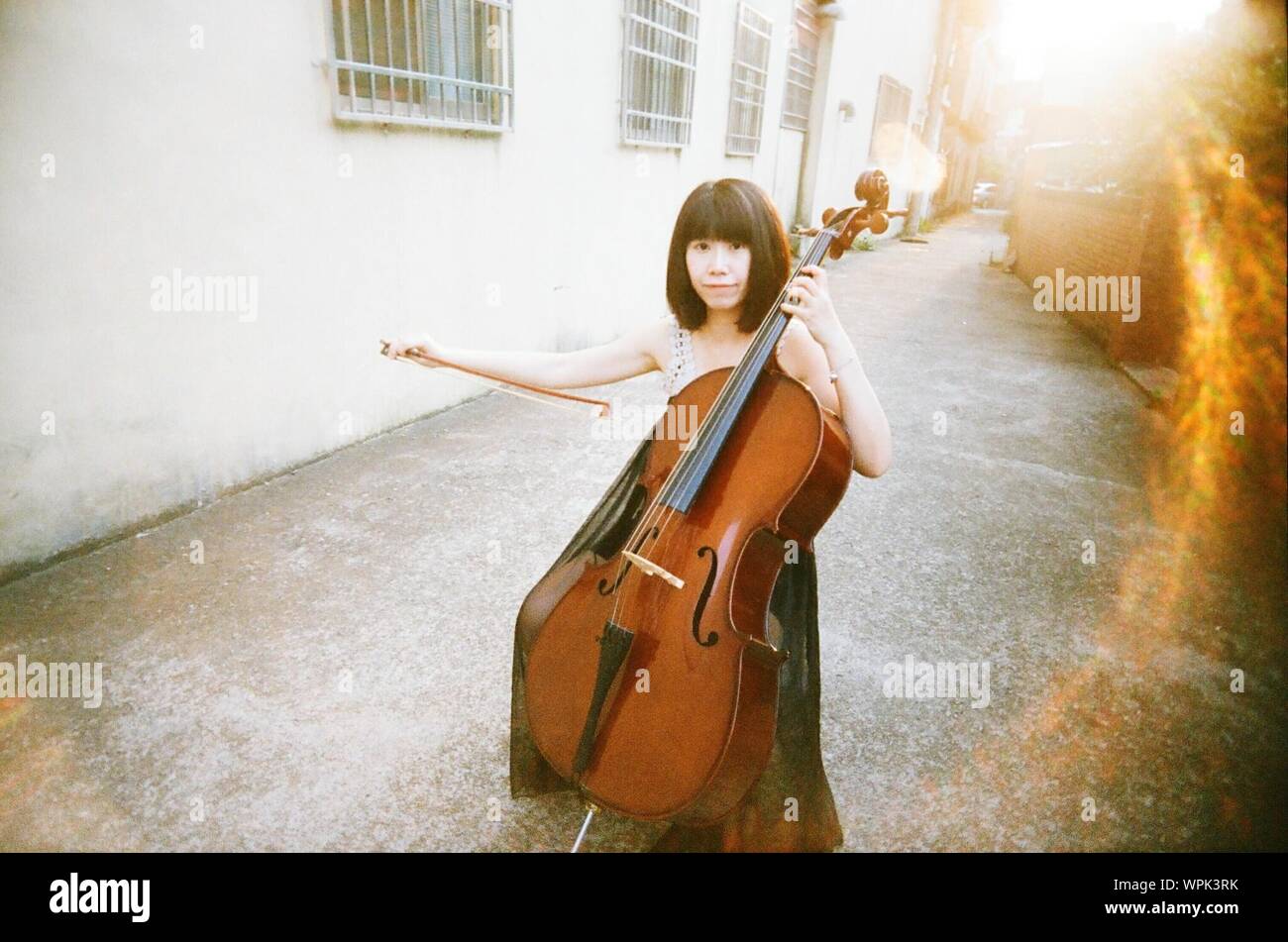 Beautiful young woman playing cello classical music instrument Stock ...