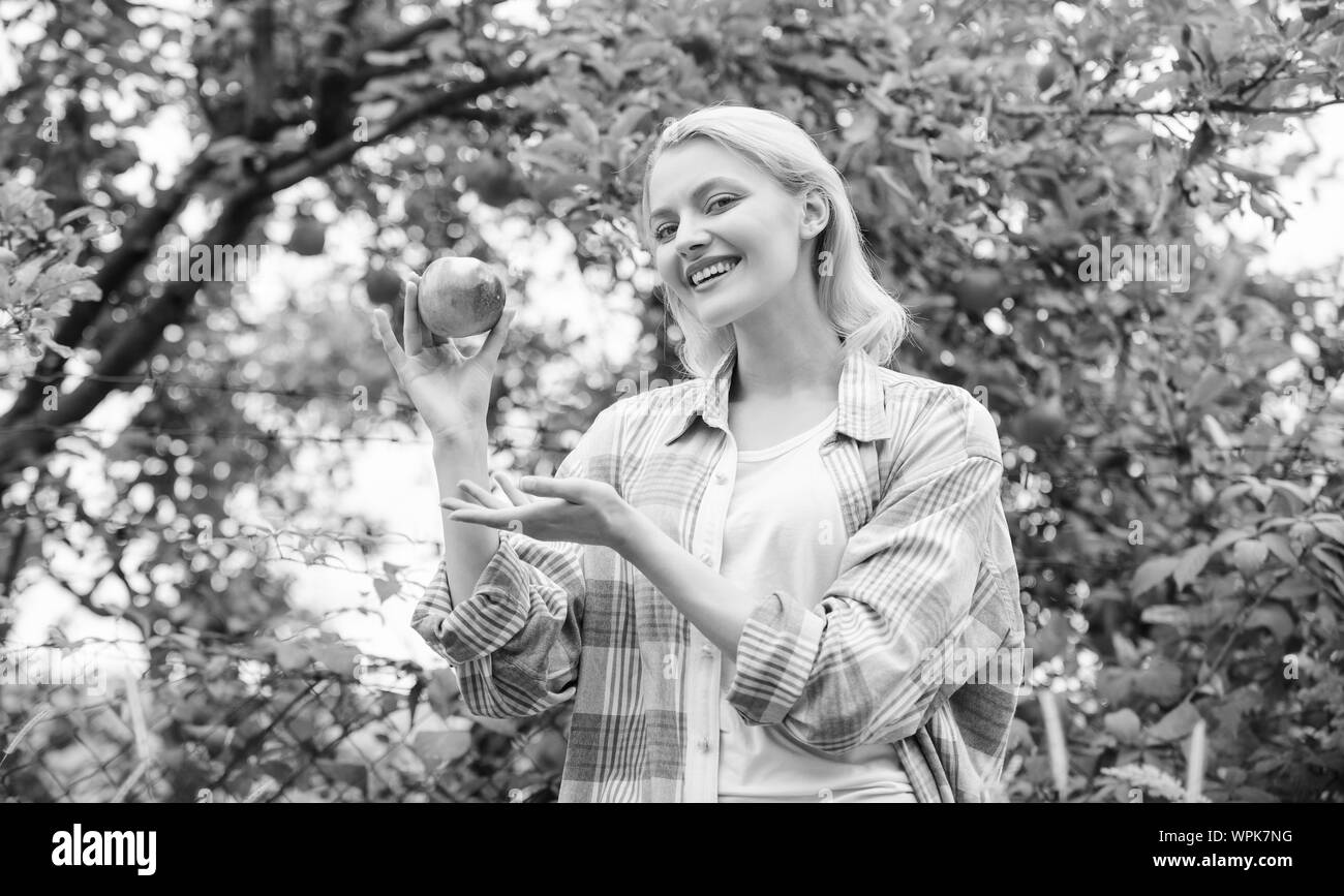 Happy woman eating apple. orchard, gardener girl in apple garden ...