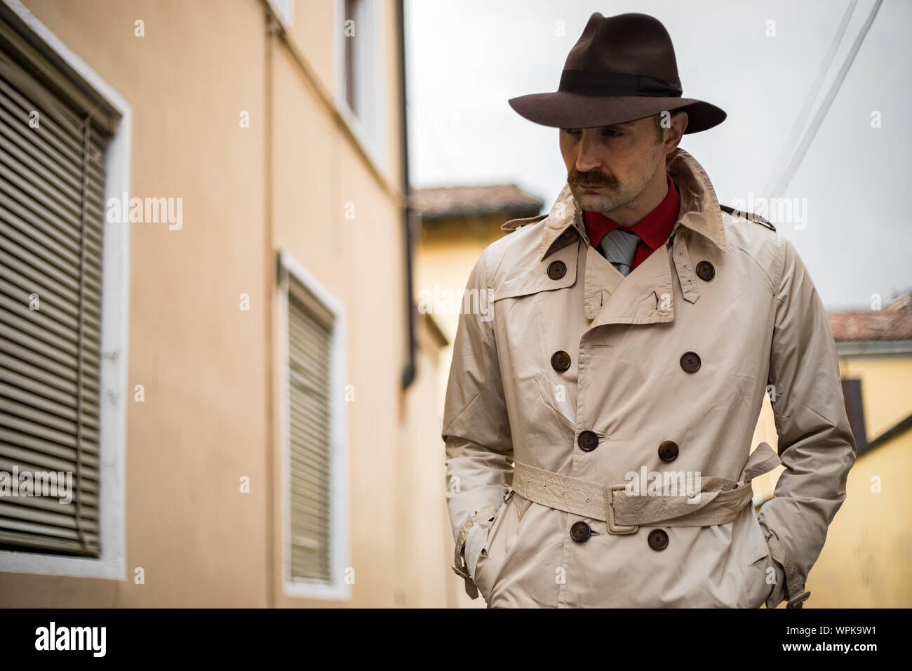 Detective walking in the city slums Stock Photo - Alamy