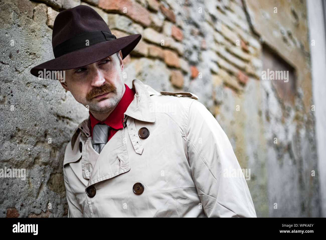 Detective walking in the city slums Stock Photo - Alamy