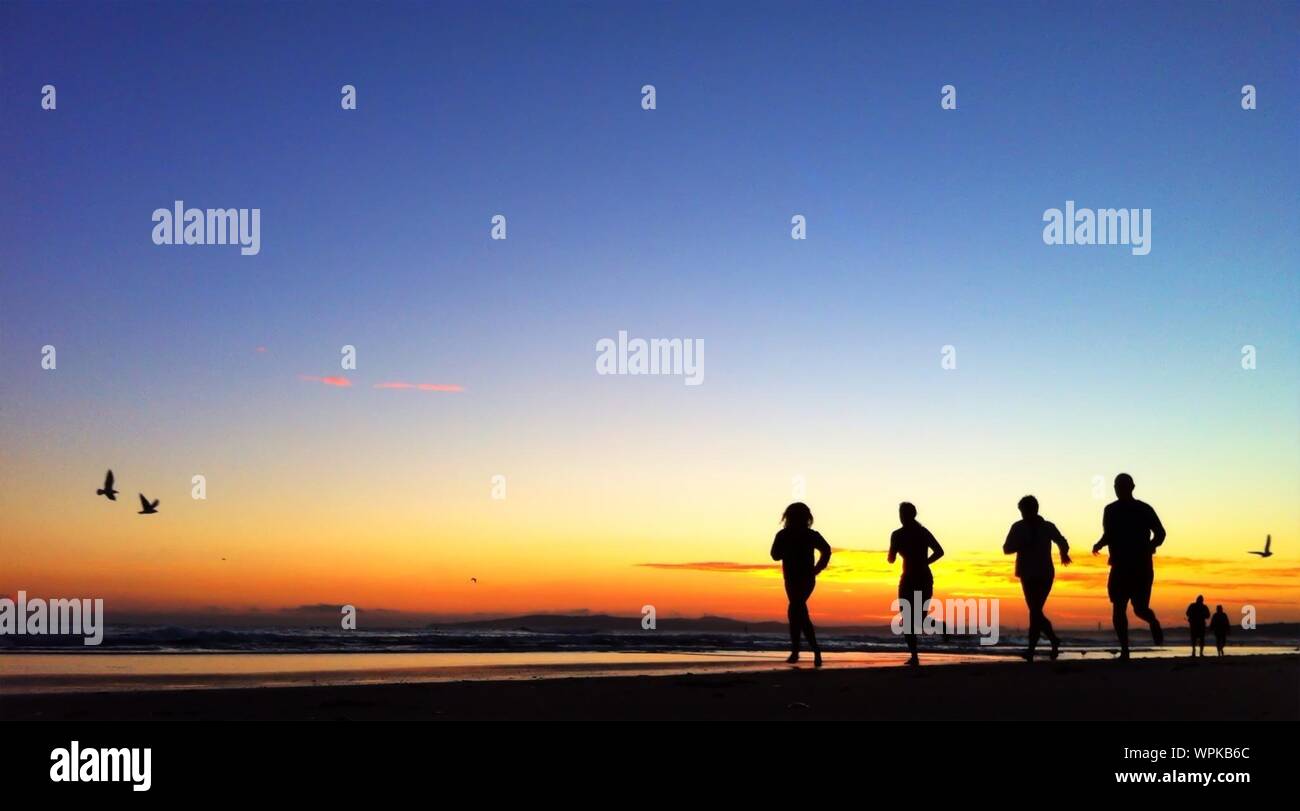 Group running into sea hi-res stock photography and images - Alamy