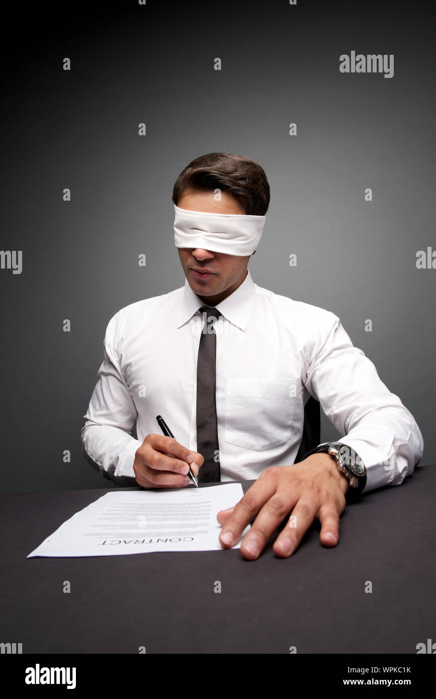 Blindfolded businessman carelessly signing a contract Stock Photo - Alamy