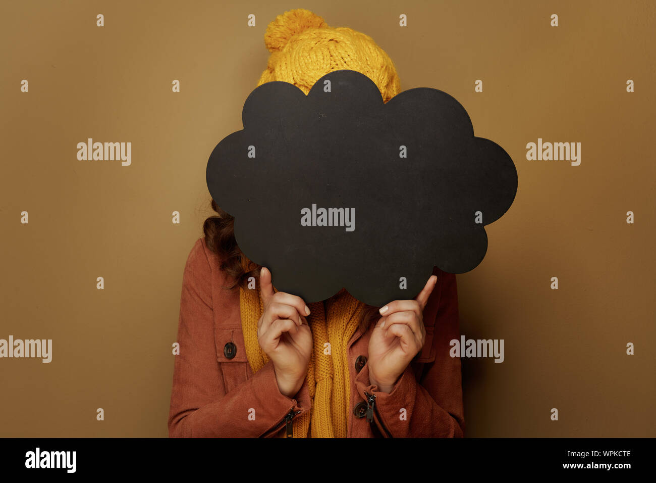 Hello autumn. modern woman in yellow beret and scarf hiding behind ...