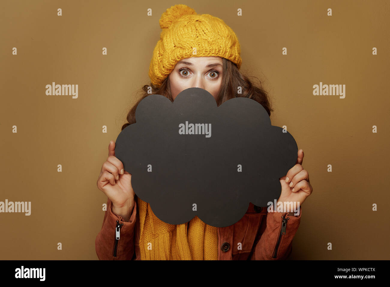 Hello autumn. surprised stylish woman in yellow beret and scarf hiding ...