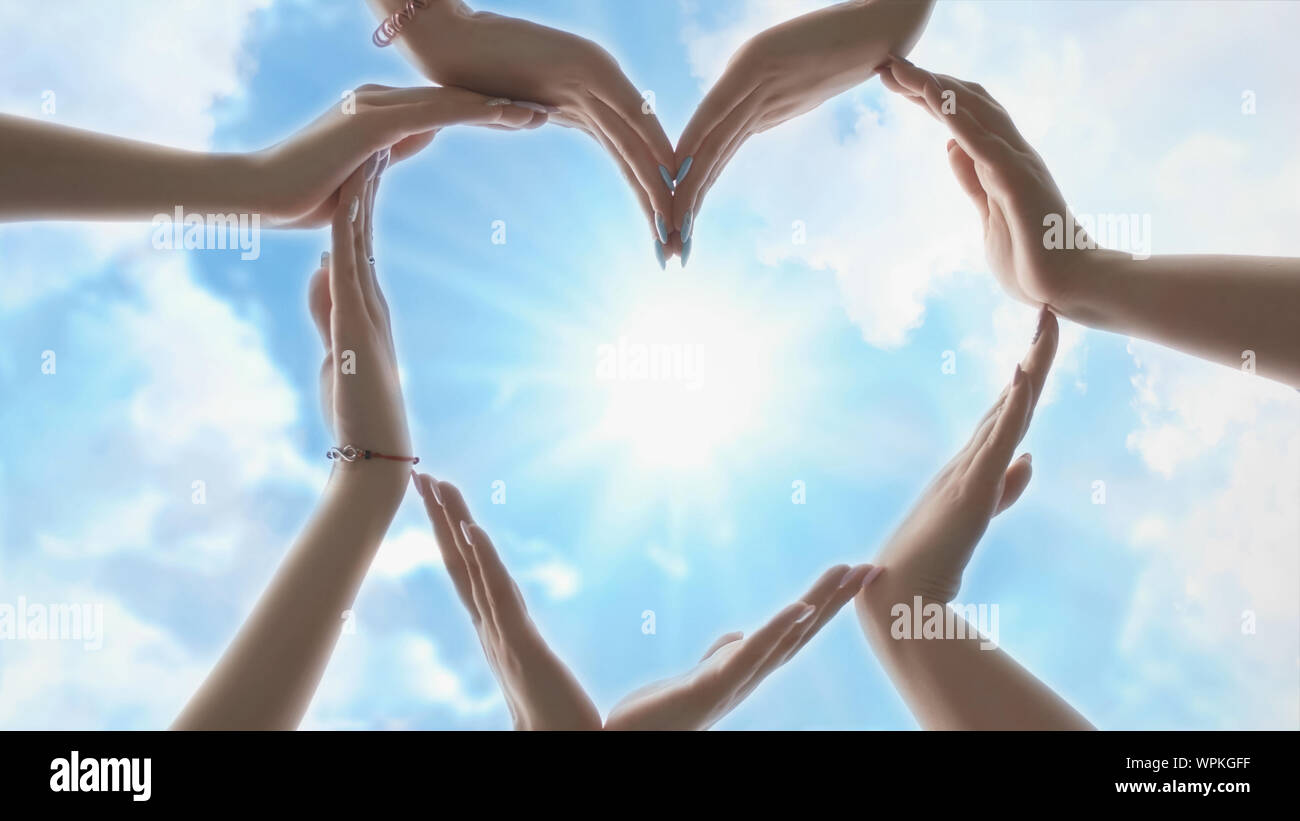 A group of youth makes a heart shape out of their hands Stock Photo - Alamy