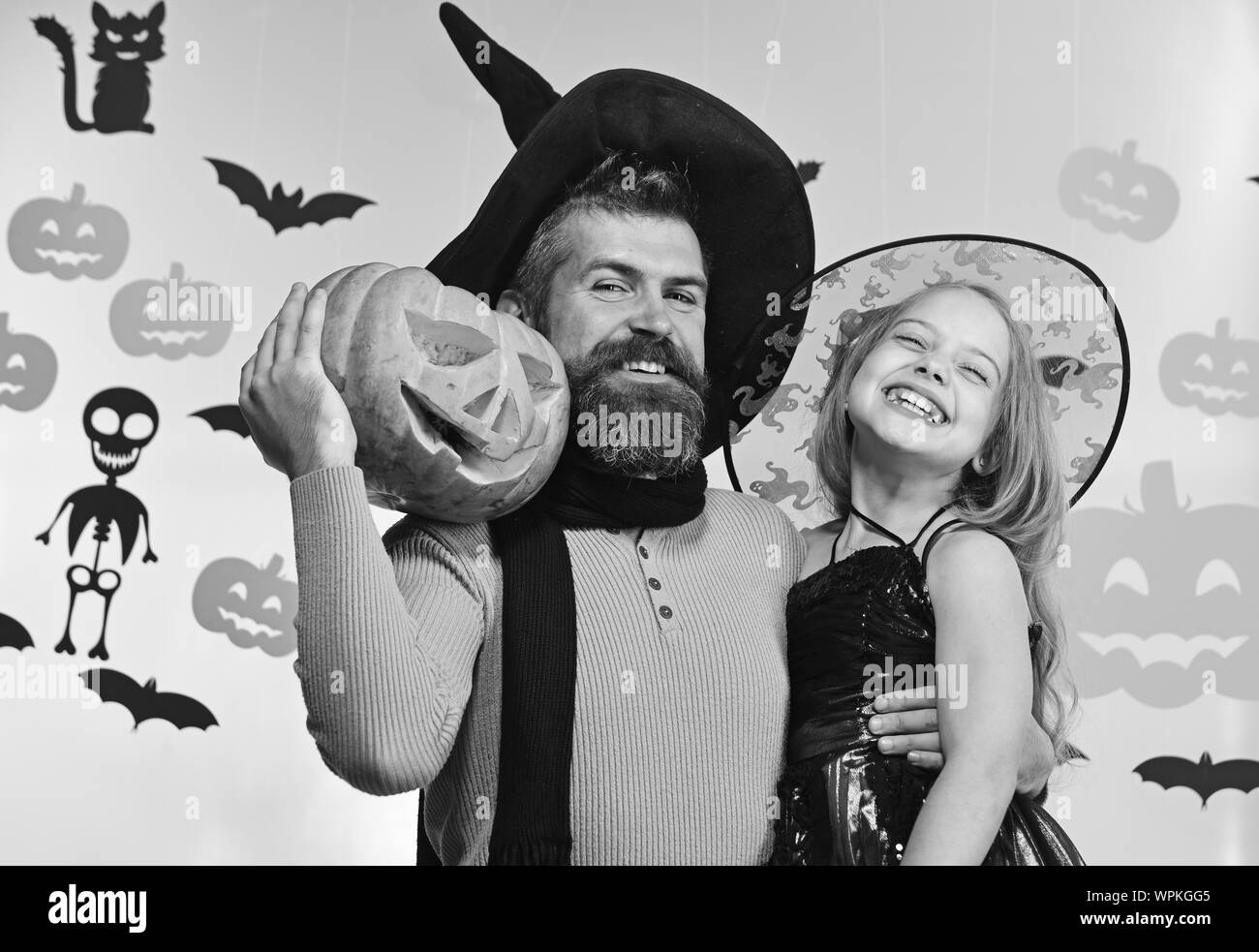 Father and daughter in costumes. Girl and bearded man with happy faces ...