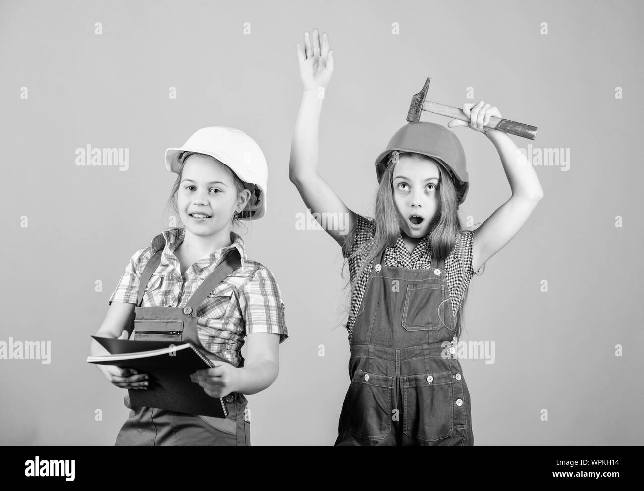 Little kids in helmet with tablet and hammer. Labor day. 1 may. small ...