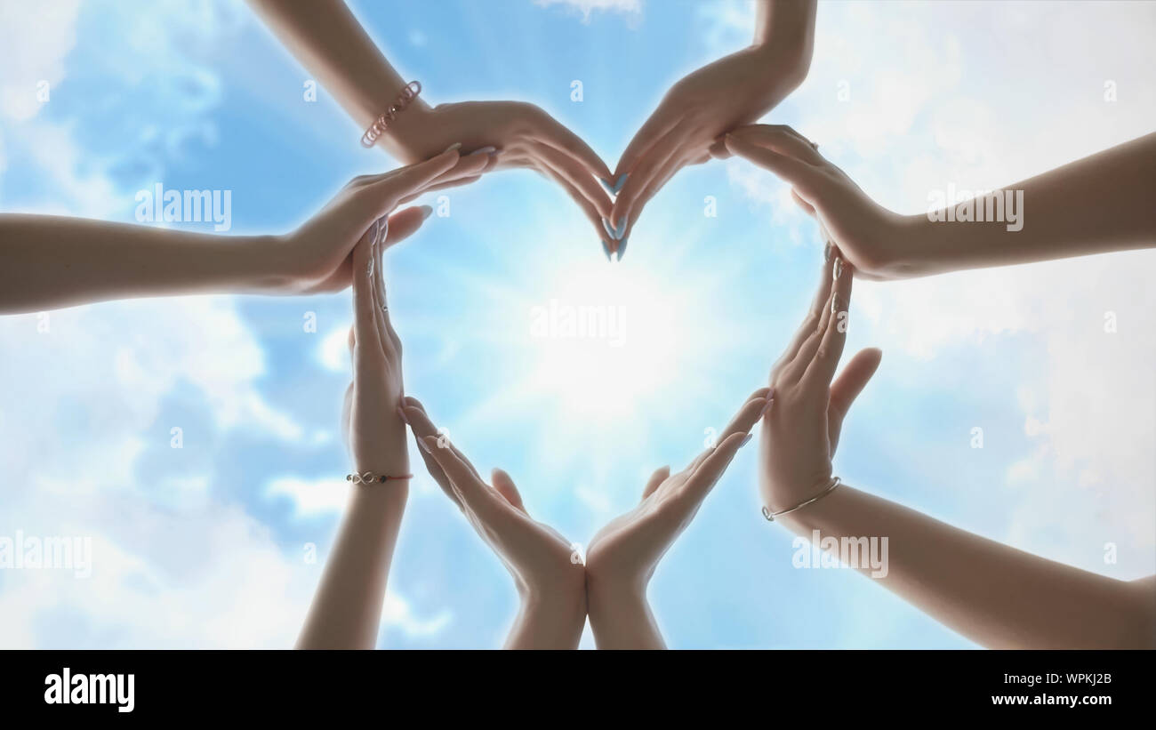A group of youth makes a heart shape out of their hands Stock Photo - Alamy