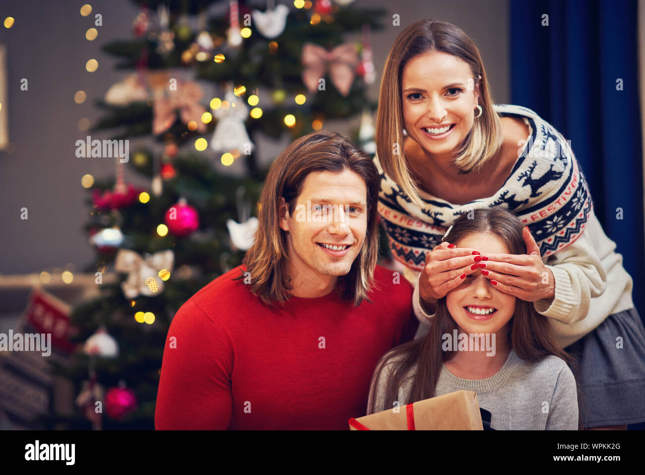 Beautiful family with presents under Christmas tree Stock Photo - Alamy