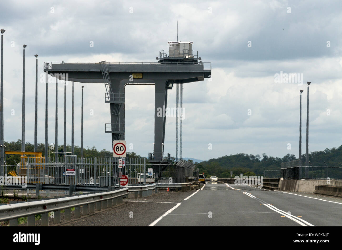 Driving across the Wivenhoe Dam with a concrete spillway across the ...
