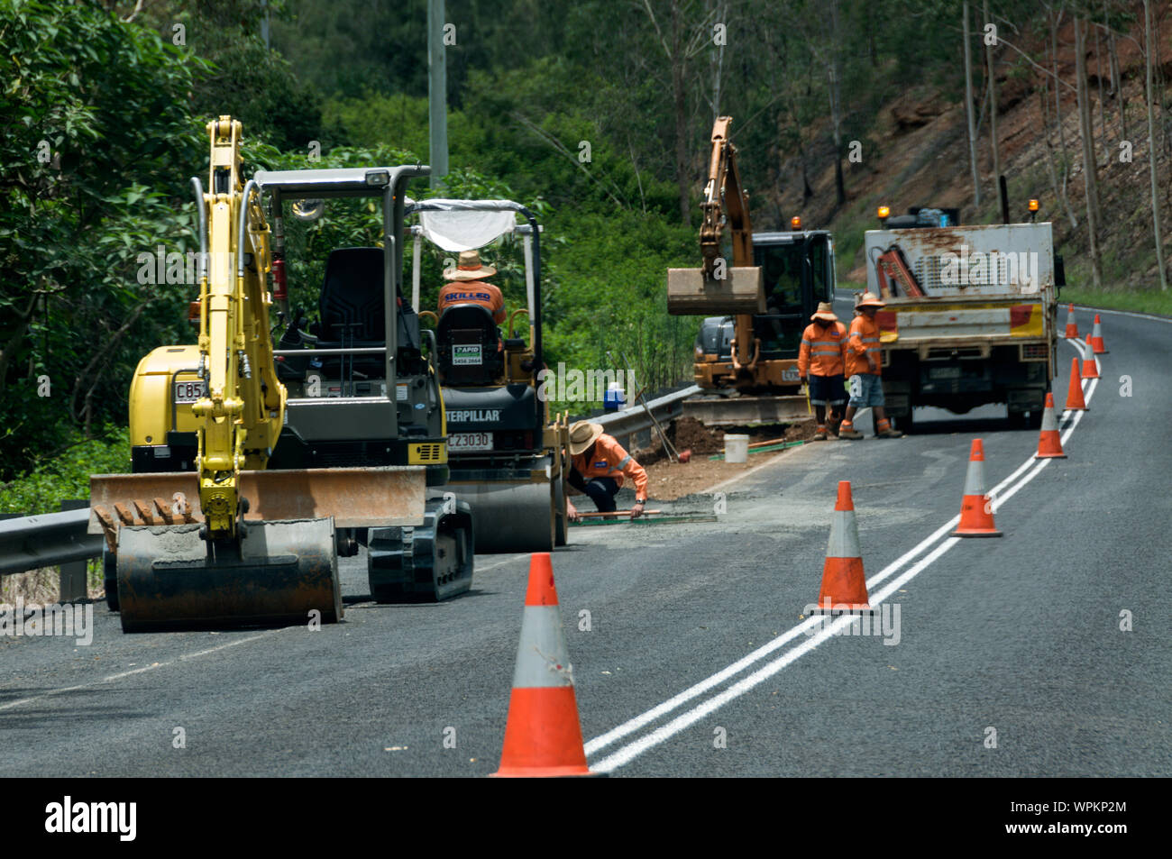 Workmen repairing a stretch of road surface on the Brisbane Valley ...