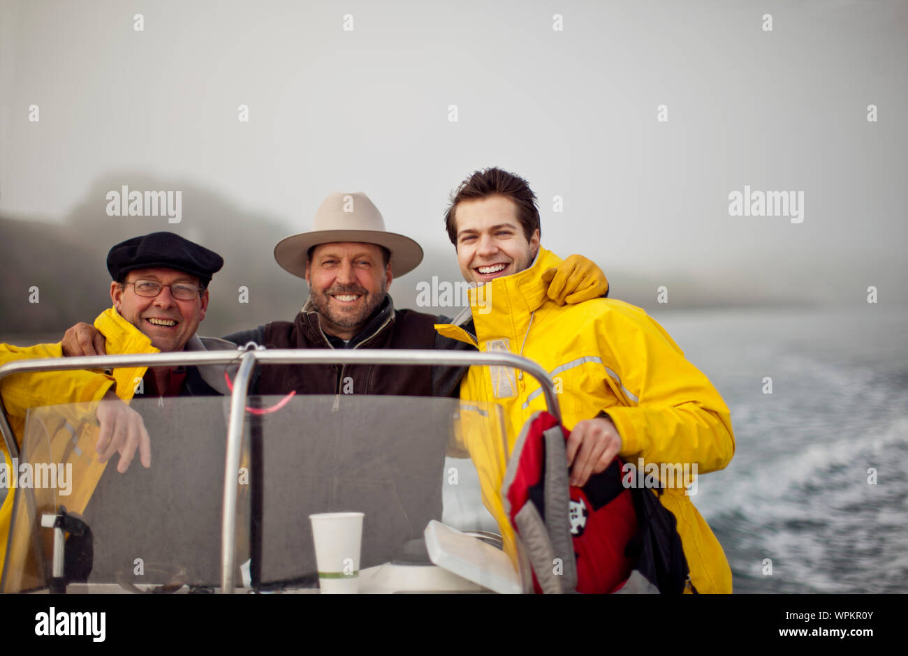 Portrait of three smiling friends on a boat Stock Photo - Alamy