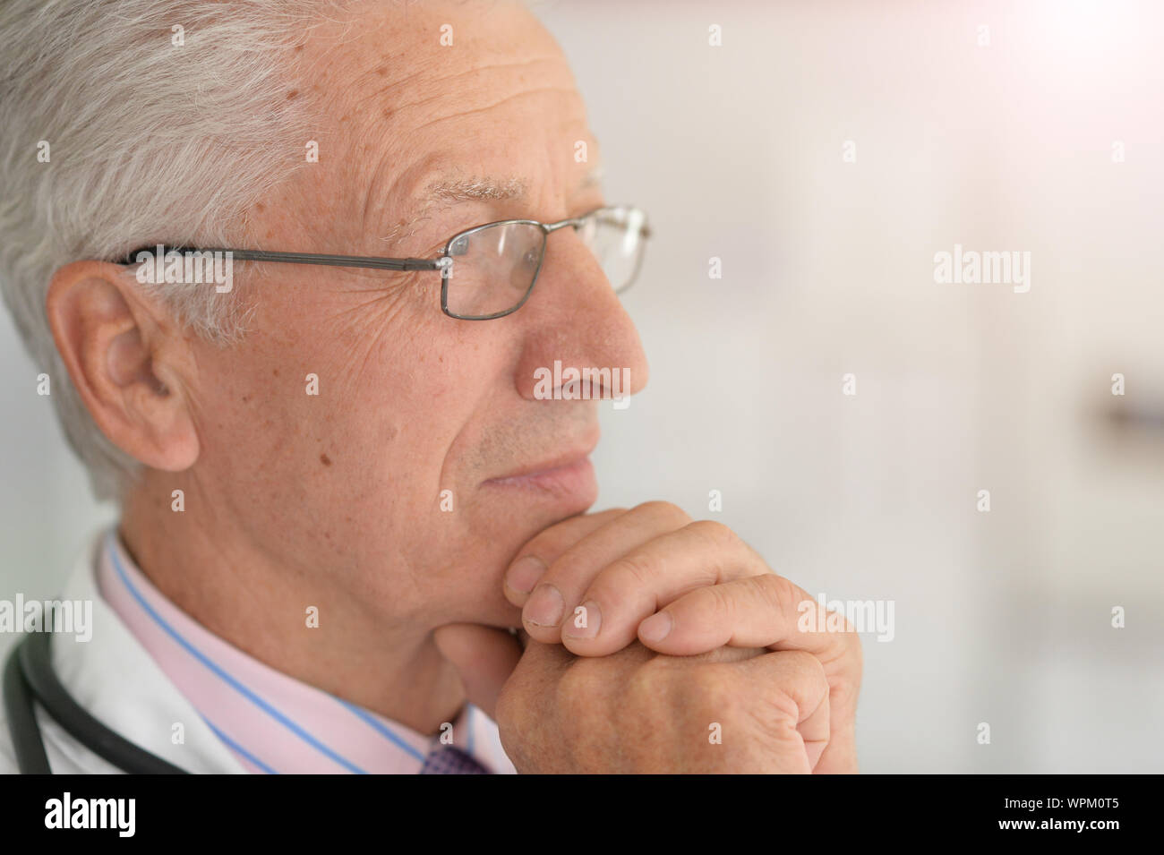 Portrait of sad senior male doctor posing Stock Photo - Alamy
