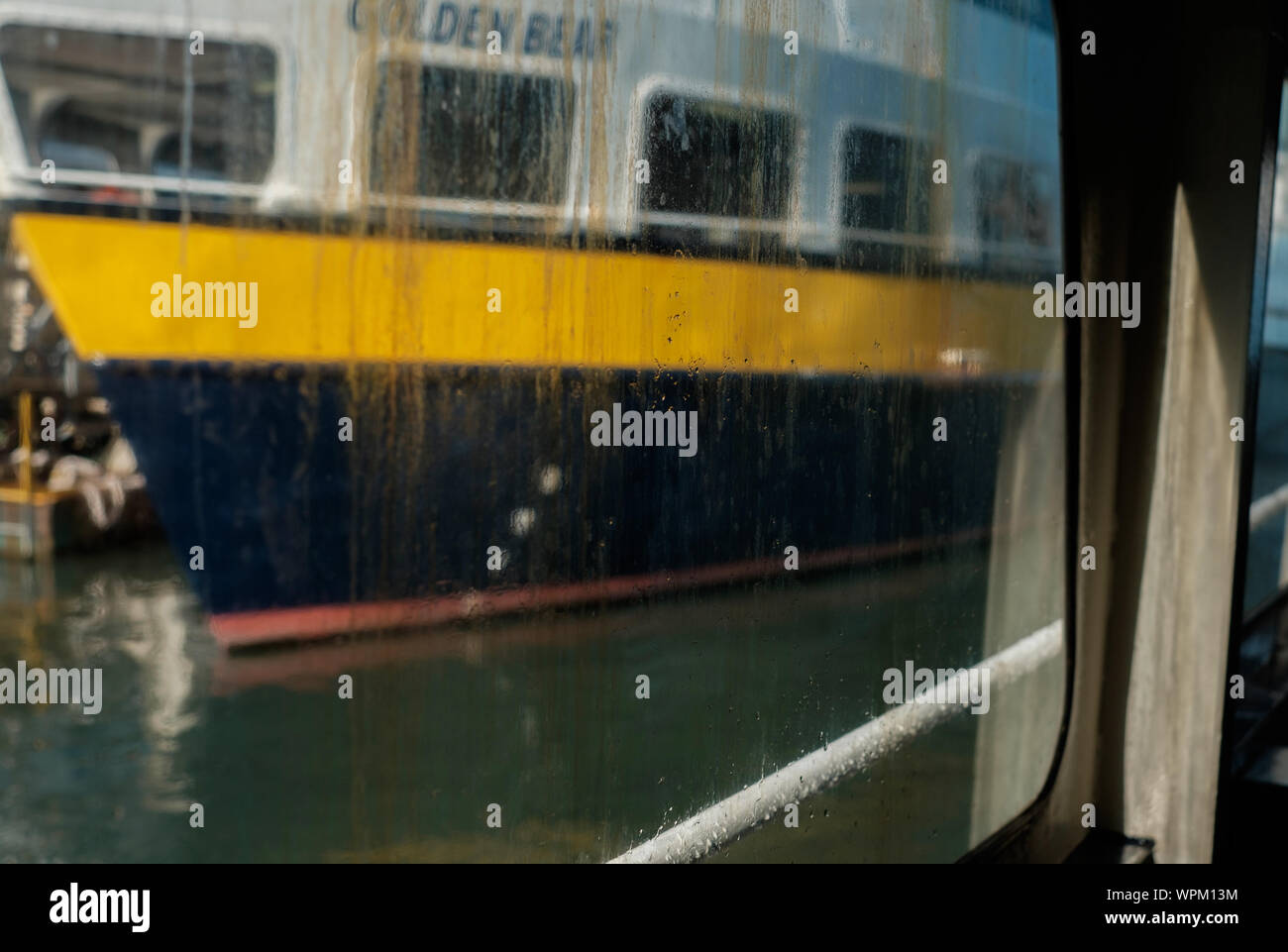 Boat at Dock through Window Stock Photo - Alamy