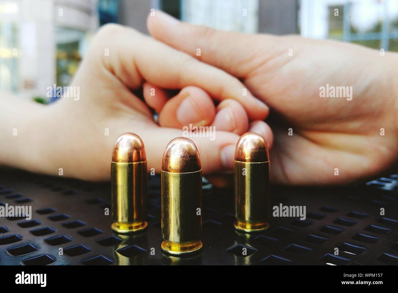 Bullet on hands hi-res stock photography and images - Alamy
