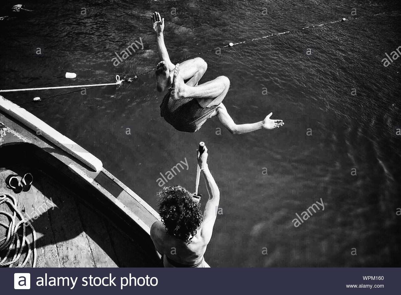 Man Diving Into Water Black and White Stock Photos & Images - Alamy
