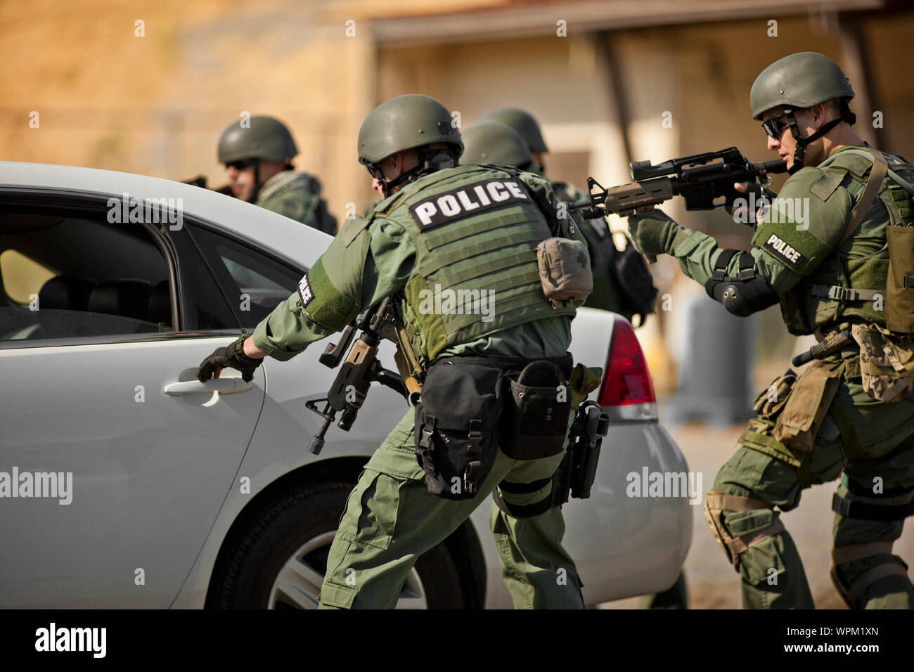 Group of police officers surround a vehicle during an exercise at a ...