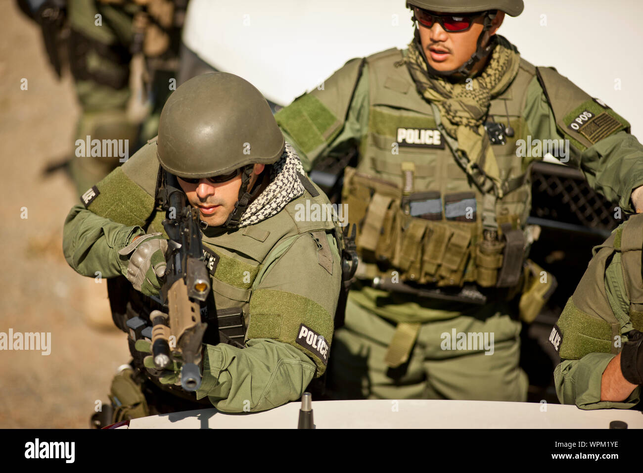 Male police officer aiming a gun toward a target during an exercise at ...