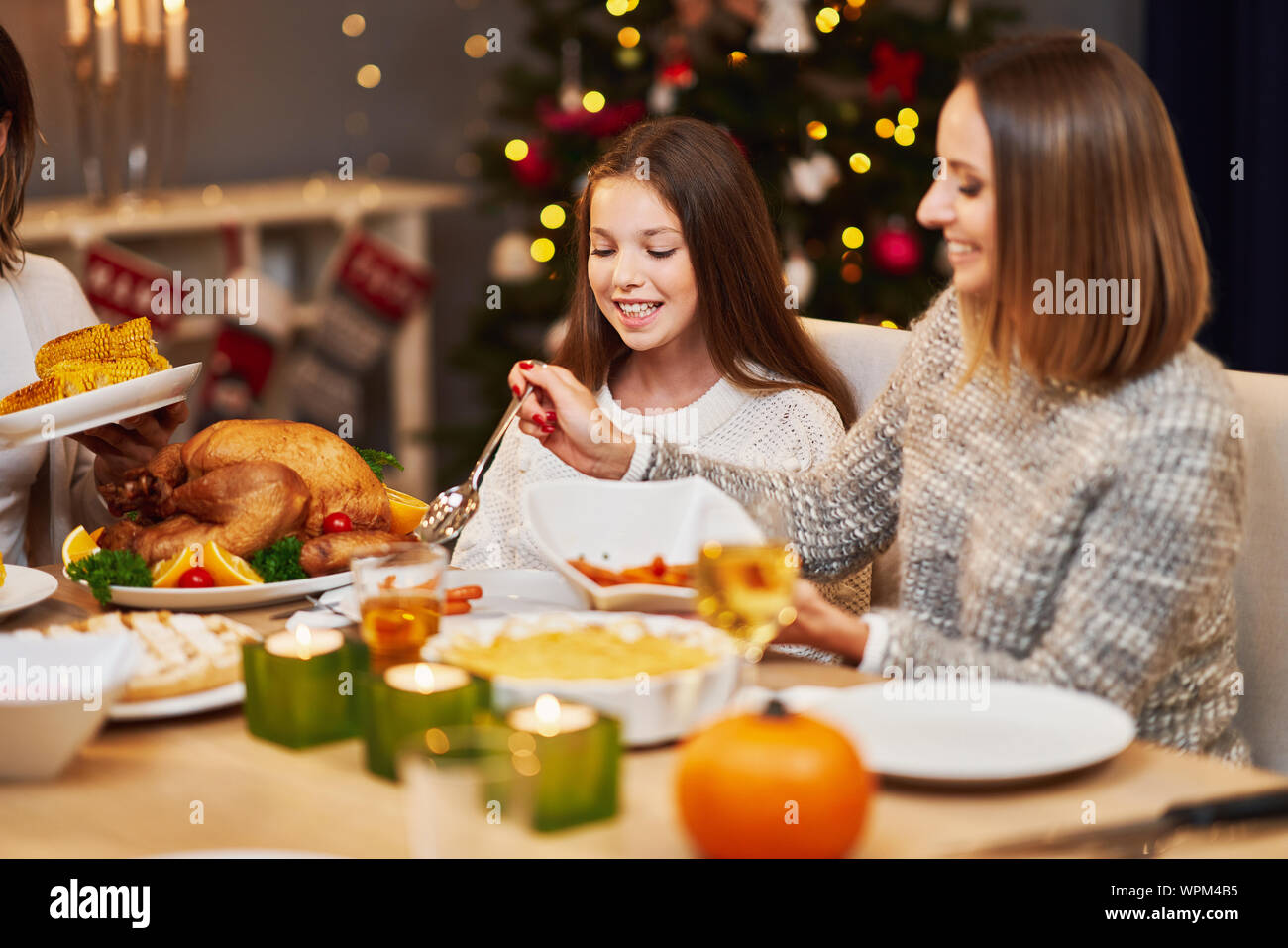 Beautiful family eating Christmas dinner at home Stock Photo - Alamy