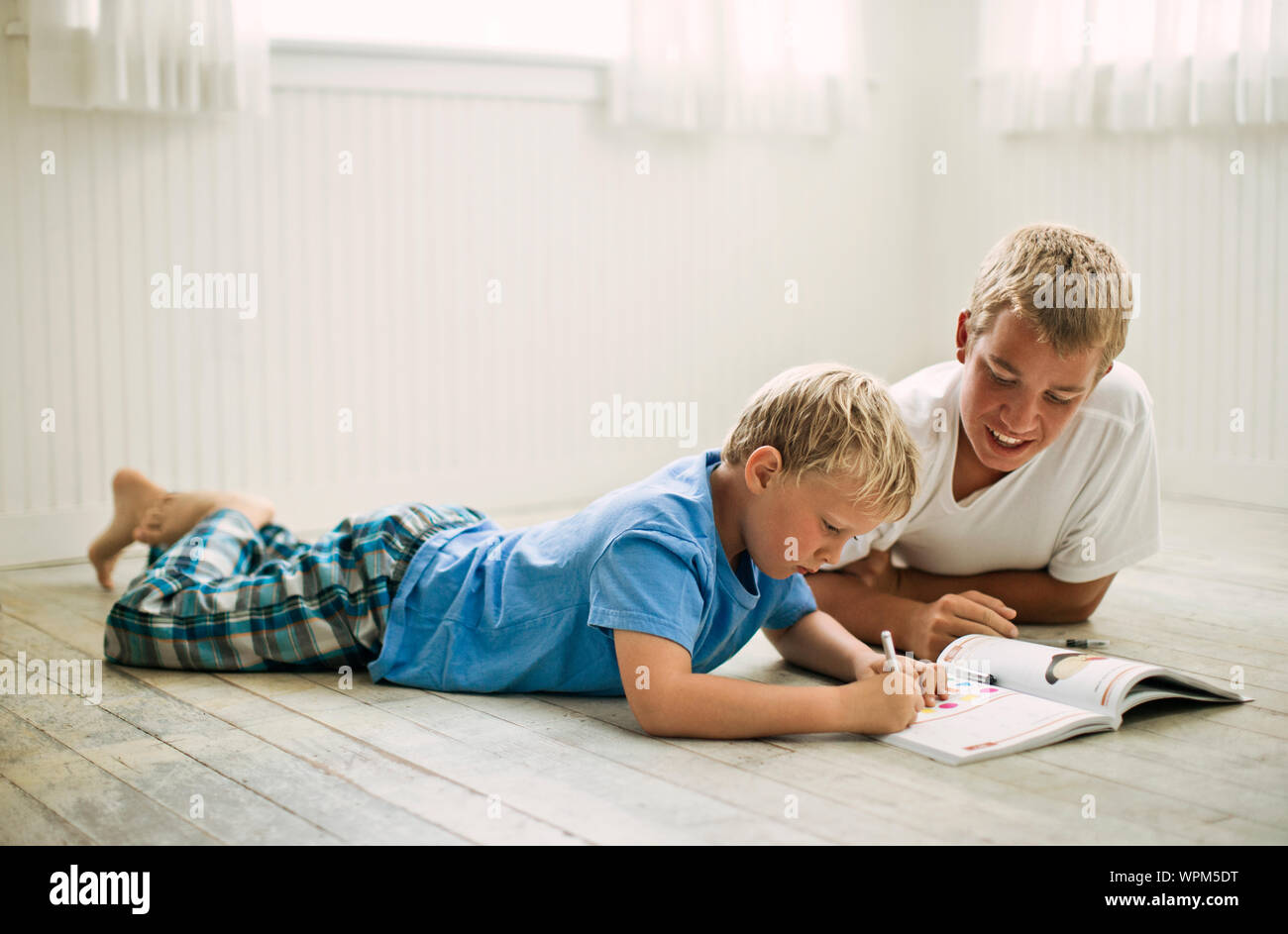 Boy helping younger brother hi-res stock photography and images - Alamy