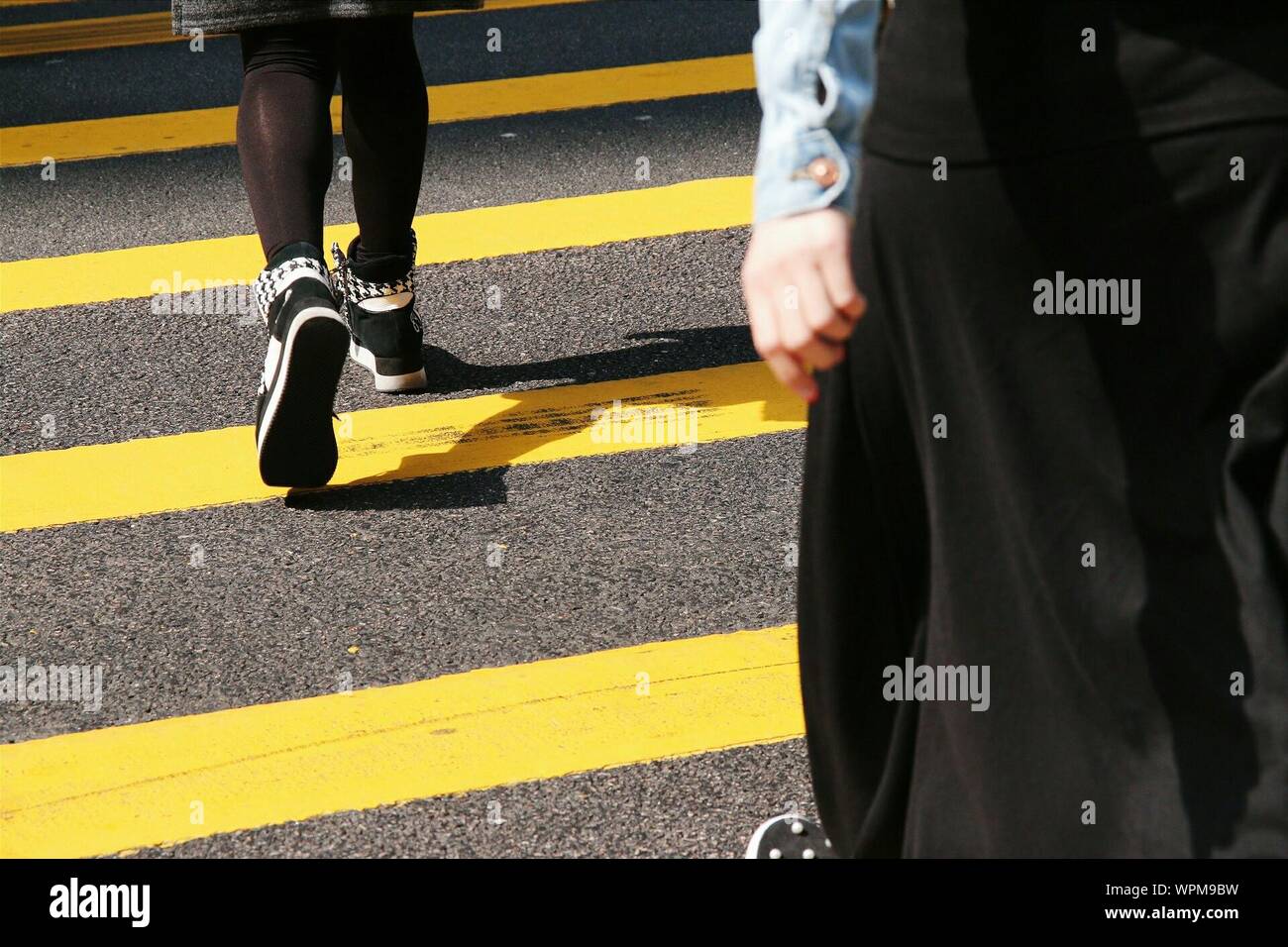Two women crossing the road hi-res stock photography and images - Alamy