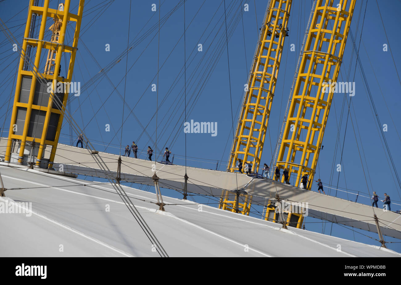 Group of people climbing the O2 Arena dome in a guided tour in London ...
