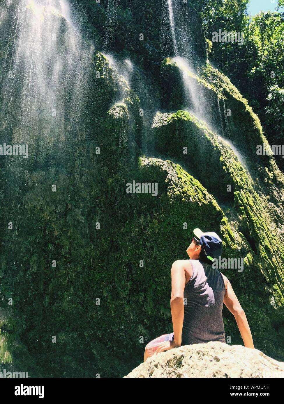 Person looking up by waterfall hi-res stock photography and images - Alamy