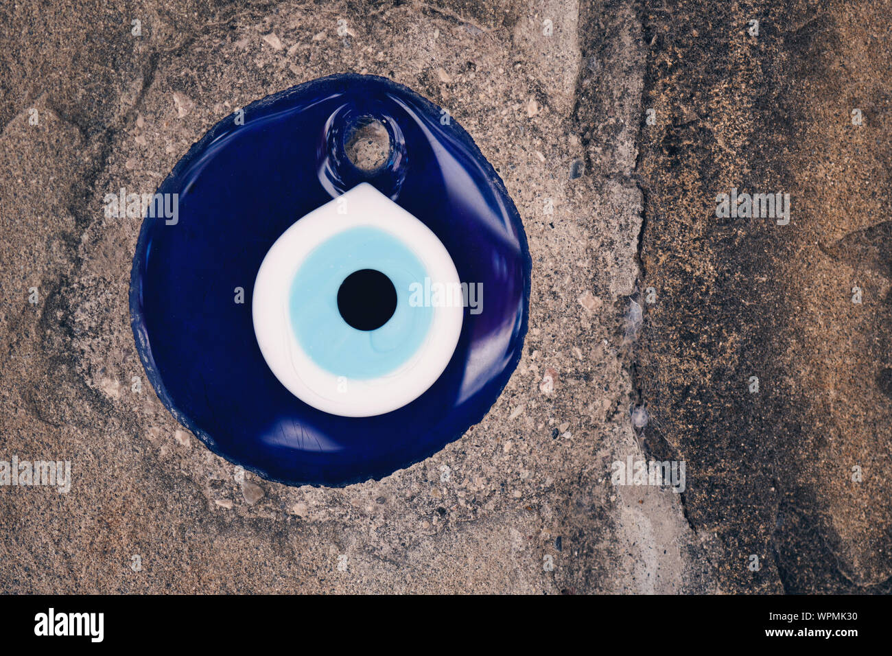 glass turkish eye on stone background Stock Photo - Alamy