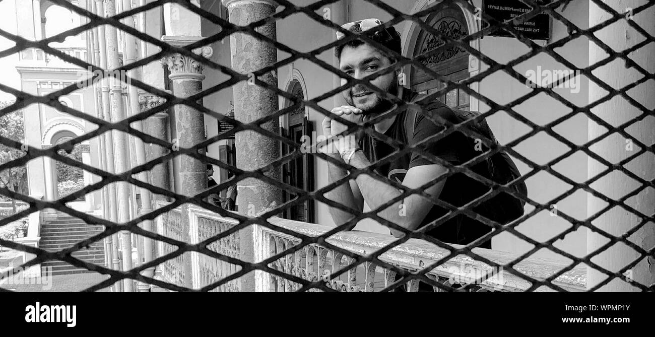 Young man standing window Black and White Stock Photos & Images - Alamy