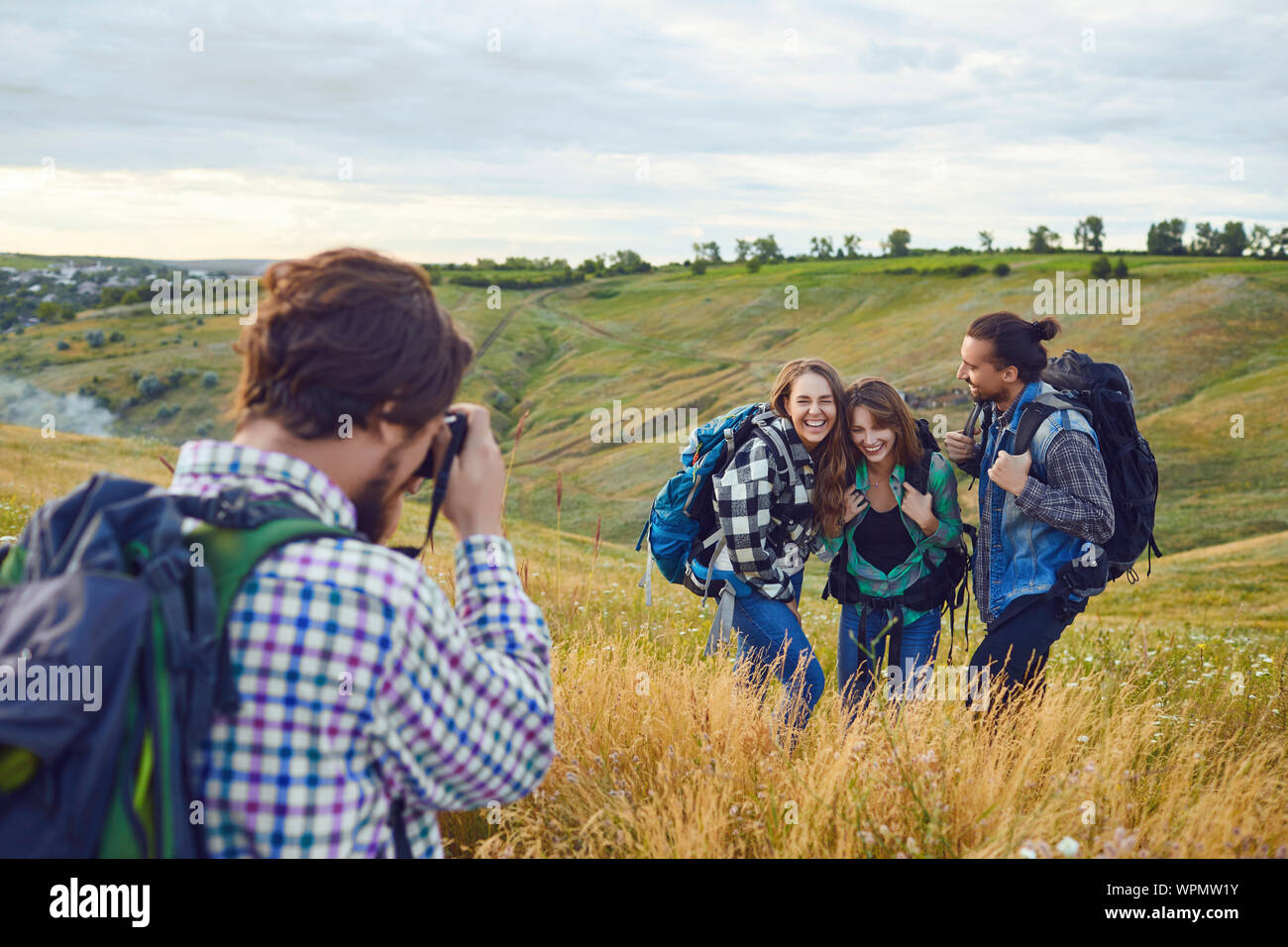 Friends smiling tourists are photographed in a hike Stock Photo - Alamy