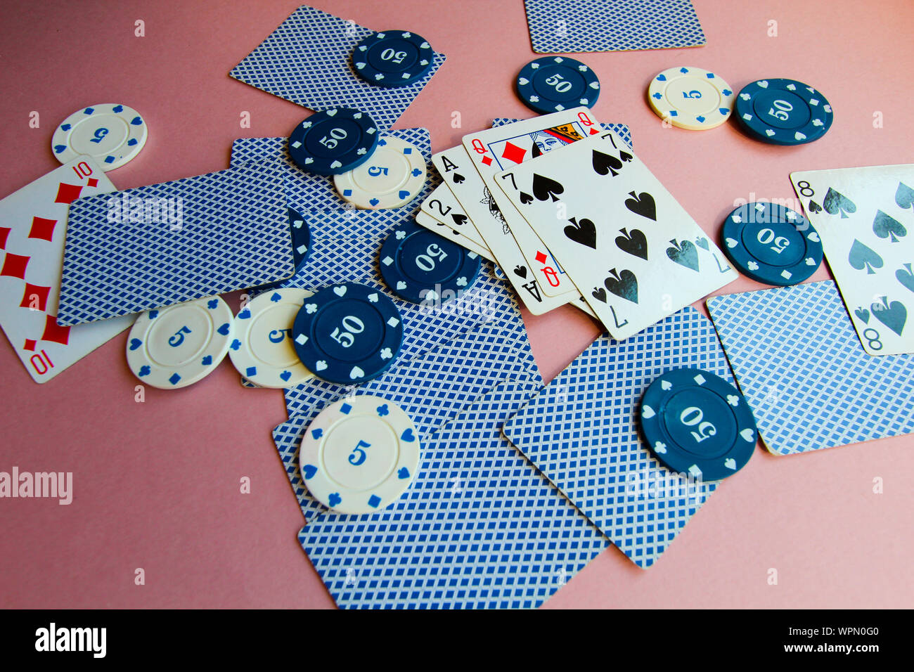 Chips and cards for poker on pink background. Cards for poker are ...