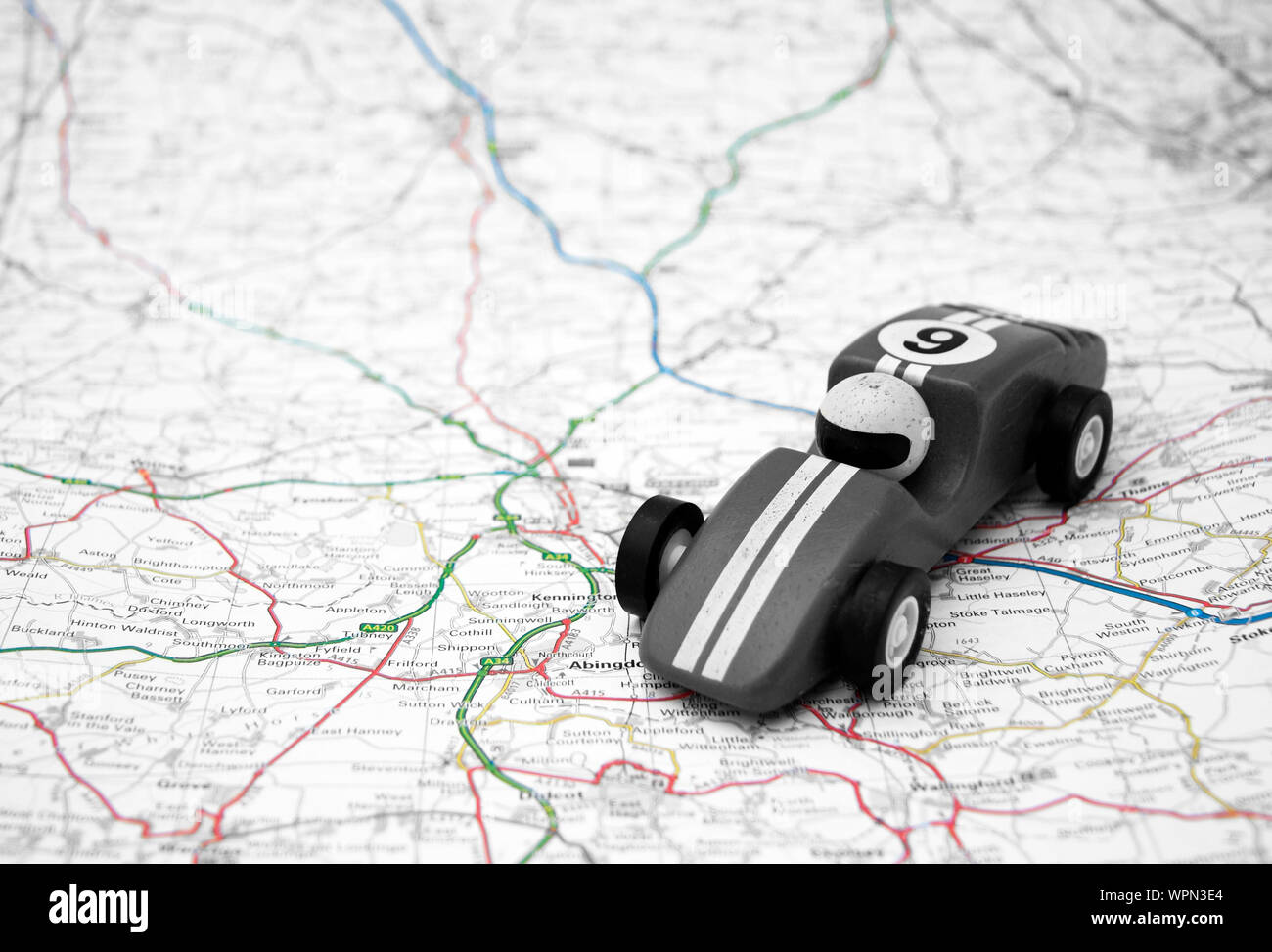 Toy racing car on a road map Stock Photo - Alamy
