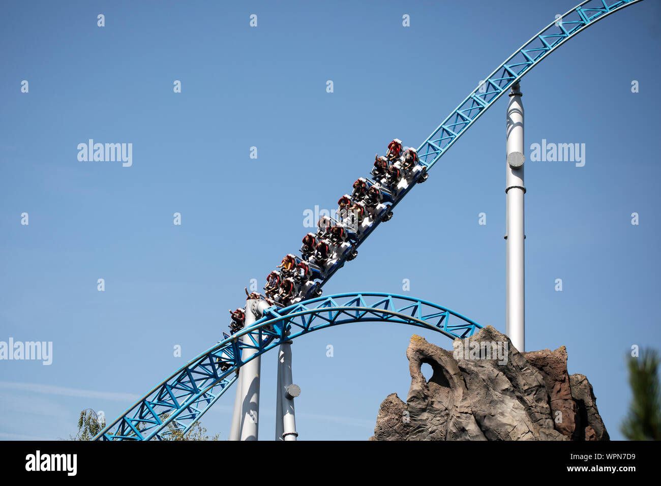 Riders descend a large hill on the Blue Fire mega coaster at Europa ...