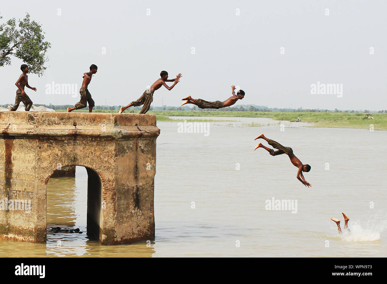 Indian boy jumping in river hi-res stock photography and images - Alamy