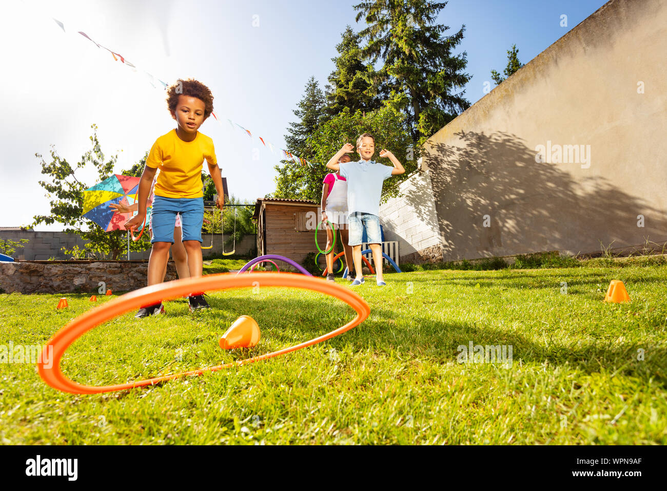 Boy throw hula rings aiming to target cone Stock Photo - Alamy